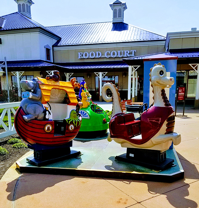 Kiddie rides outside the food court: where loose change transforms into three minutes of blessed shopping peace.
