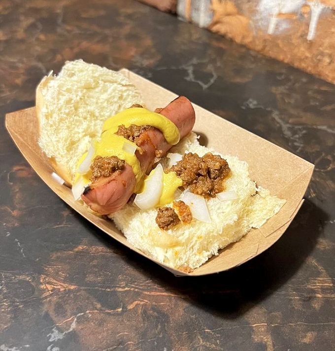 Hot dog heaven with a Detroit twist. This coney-inspired slider, topped with mustard and what appears to be chili, delivers big flavor in a small package.