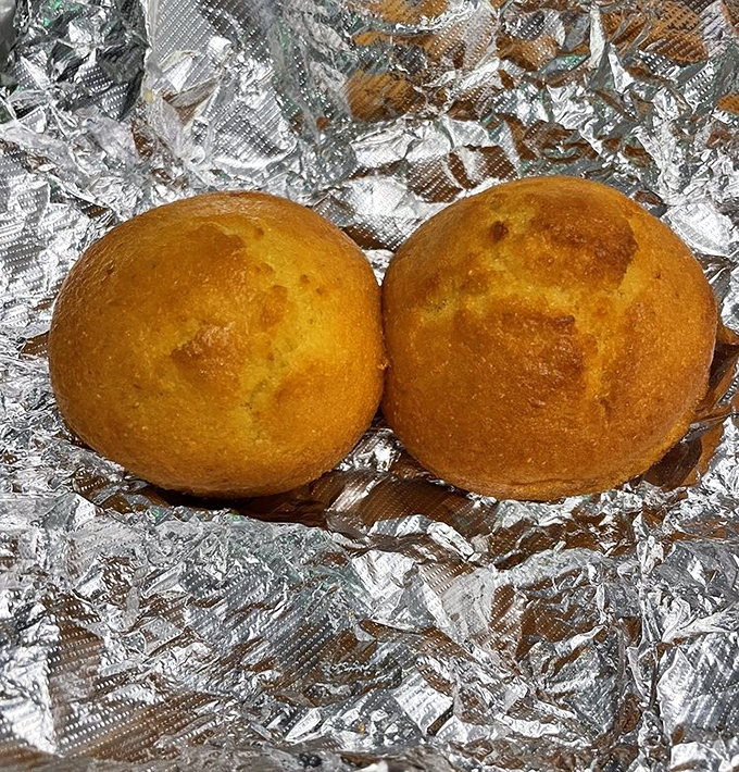 Cornbread muffins with that perfect golden dome&mdash;crusty on the outside, tender inside&mdash;ready to perform their sacred duty of gravy-soaking.