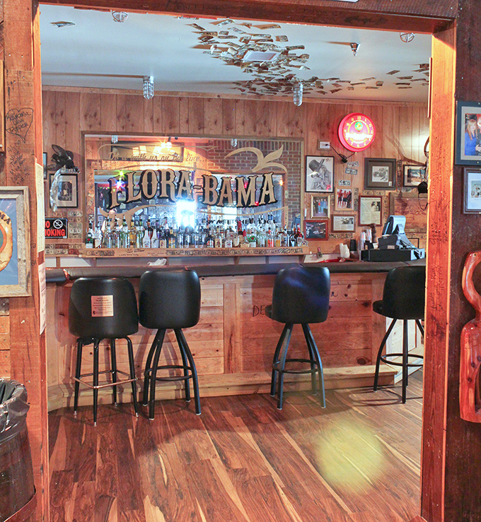 The bar area glows with amber warmth, inviting you to pull up a stool and listen to stories that get taller with each Bushwacker ordered.