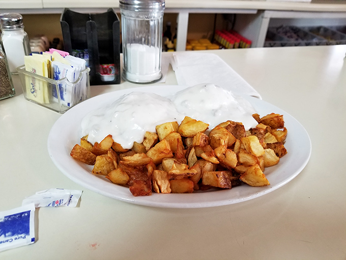 Country eggs Benedict smothered in gravy&mdash;because sometimes the best way to start your day is with delicious excess.