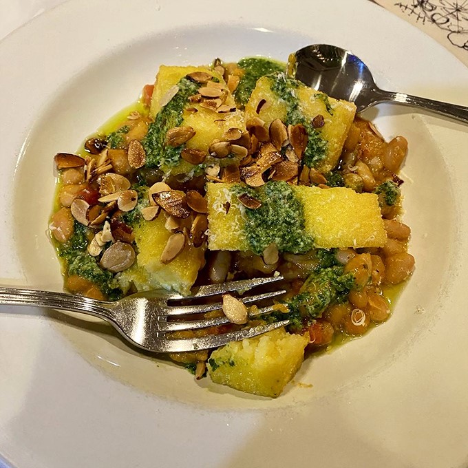 Polenta squares swimming in herb sauce with toasted seeds&mdash;proof that breakfast can be both art gallery beautiful and lumberjack satisfying.