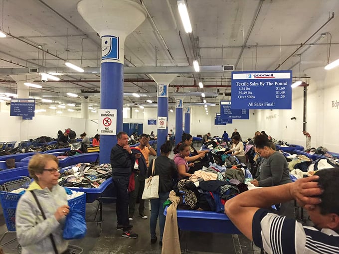 The blue signs tell the tale: textiles by the pound. The true bargain hunters know exactly which bins to target first.