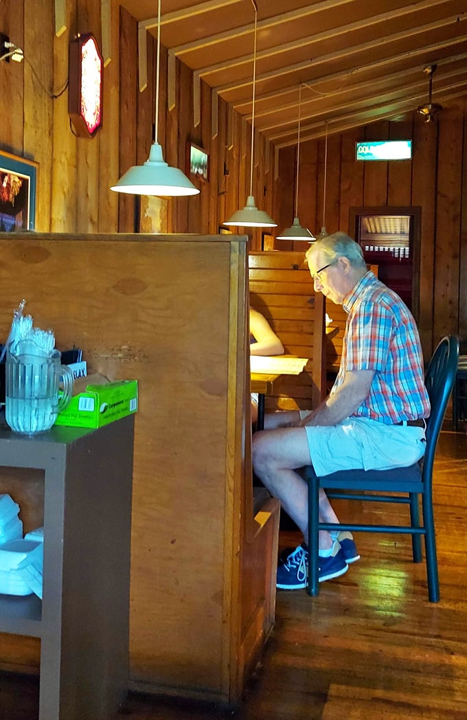 Cozy wooden booths create intimate dining spaces where memories are made between bites of perfectly prepared steak.