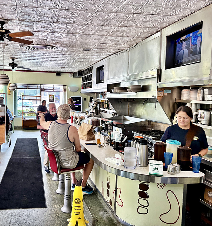 Where coffee refills flow as freely as conversation, and regulars hold court at the counter like professors at their lecterns.