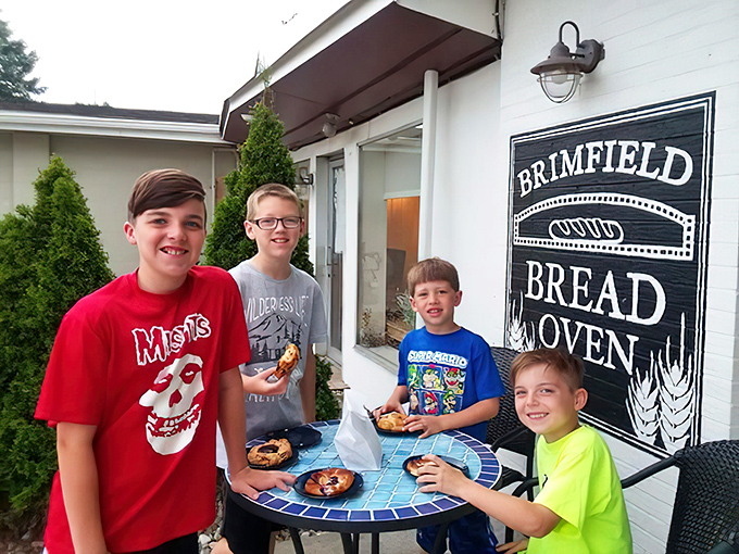 Happy kids enjoying pizza outdoors&mdash;proof that good taste starts young. Future food critics in training with excellent pizza priorities.