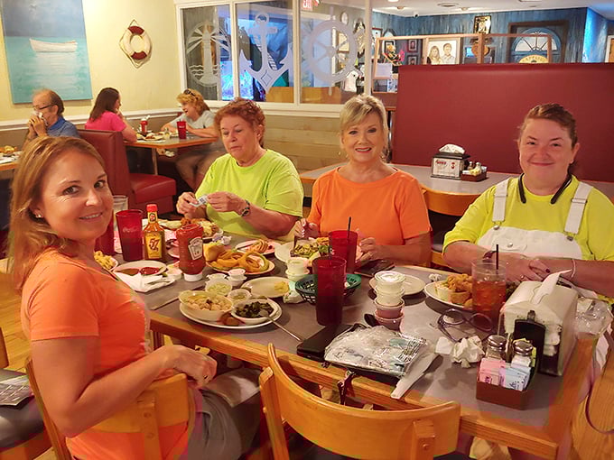 Happy diners sharing a meal and memories at Captain Steve's. The orange shirts might be coincidental, but the satisfied smiles definitely aren't.