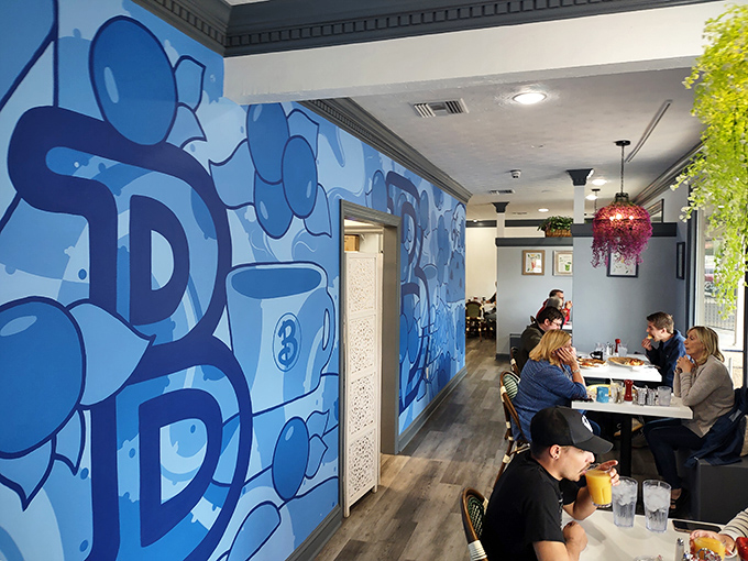 The blue-themed mural creates the perfect backdrop for diners enjoying that magical moment when coffee meets breakfast in perfect harmony.