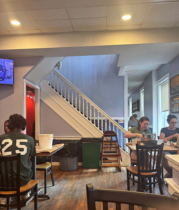 The staircase reveals L.P. Steamers' rowhouse origins, where diners happily crack, pick, and savor their way through Baltimore's seafood tradition.