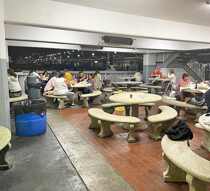 The dinner crowd gathers under twinkling lights, proving good seafood brings people together like a delicious magnet.