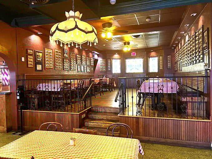 The dining area feels like a community gathering spot, with walls showcasing decades of history and those signature hanging lamps watching over it all.