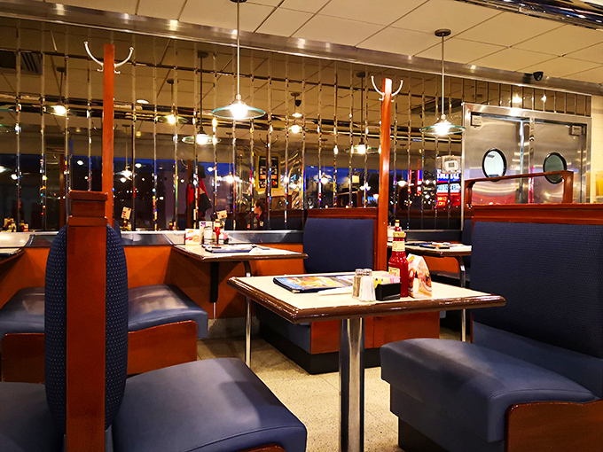 Evening transforms the dining area into a cozy retreat. Those blue booths have heard decades of first dates, family celebrations, and "let's split a slice of pie" negotiations.