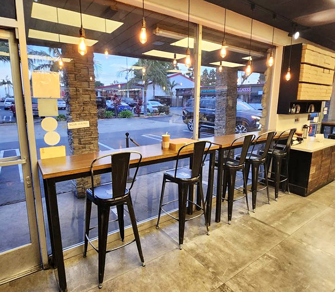 Window seating with pendant lighting creates an atmosphere far fancier than "eating donuts for breakfast" technically deserves.