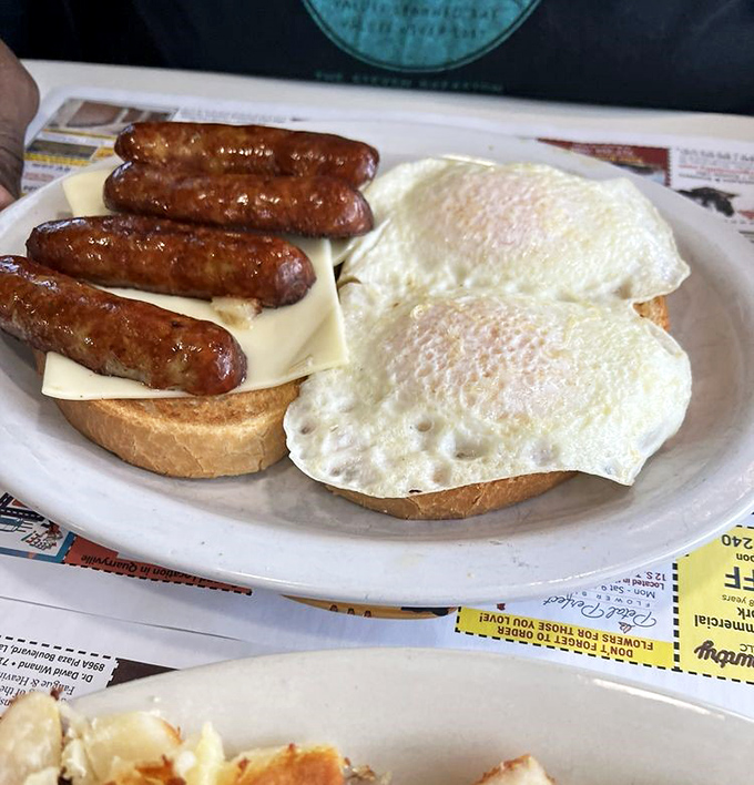 Breakfast architecture at its finest. Those sausage links aren't just meat; they're edible exclamation points on a morning masterpiece.