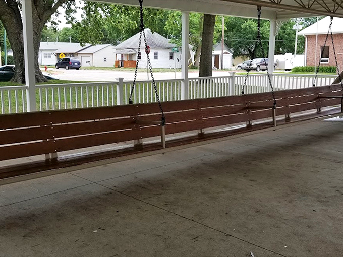 Empty now, but ready for a busload of visitors. The polished wooden slats gleam invitingly, promising a gentle sway beneath Nebraska's vast sky.