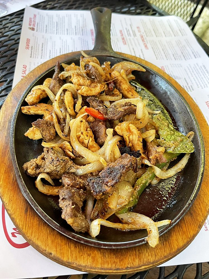 Sizzling fajitas that announce their arrival with a theatrical hiss, promising a DIY feast of perfectly charred meat and caramelized onions.