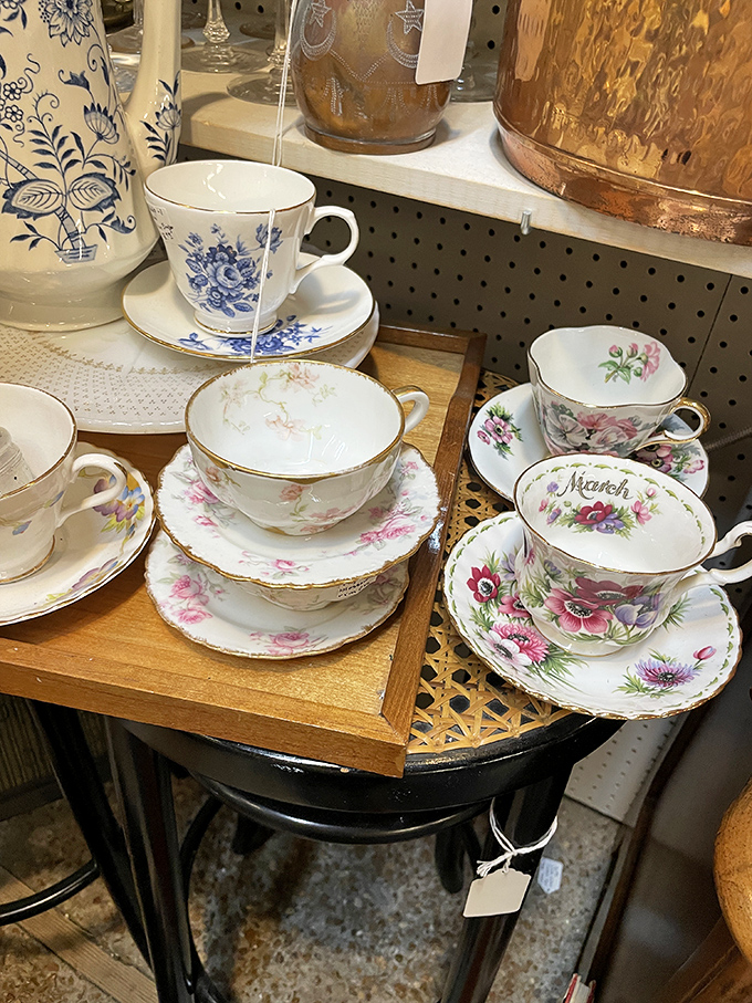 Delicate teacups with hand-painted florals await afternoon conversations, their gold-rimmed edges hinting at genteel gatherings of yesteryear.