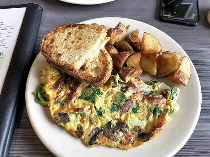 An omelet that clearly went to finishing school&mdash;perfectly folded, generously filled, and keeping excellent company with those golden home fries.