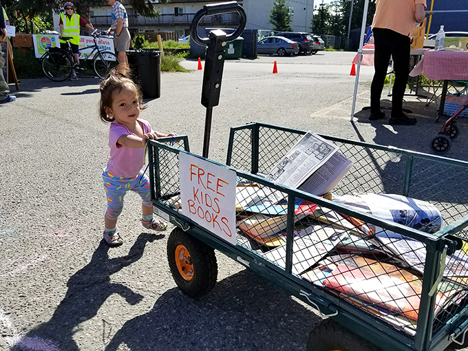 "Free Kids Books" wagon—literary treasures on wheels, proving that the best Alaskan adventures sometimes start on the page.