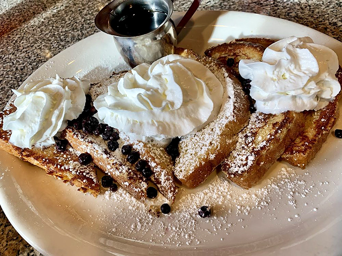French toast that turns breakfast into dessert, with clouds of whipped cream and powdered sugar snow making mornings worth waking up for.