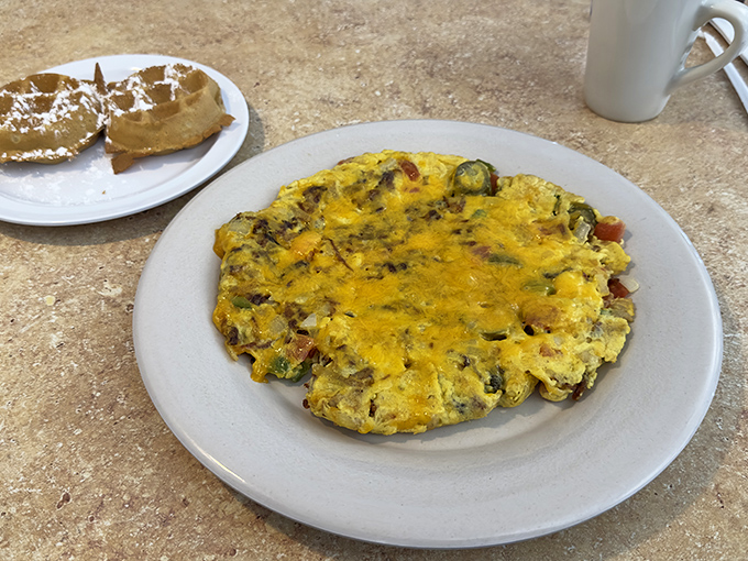 An omelet so stuffed with goodies it's practically a breakfast pi&ntilde;ata, waiting to release its treasure of flavors with each bite.