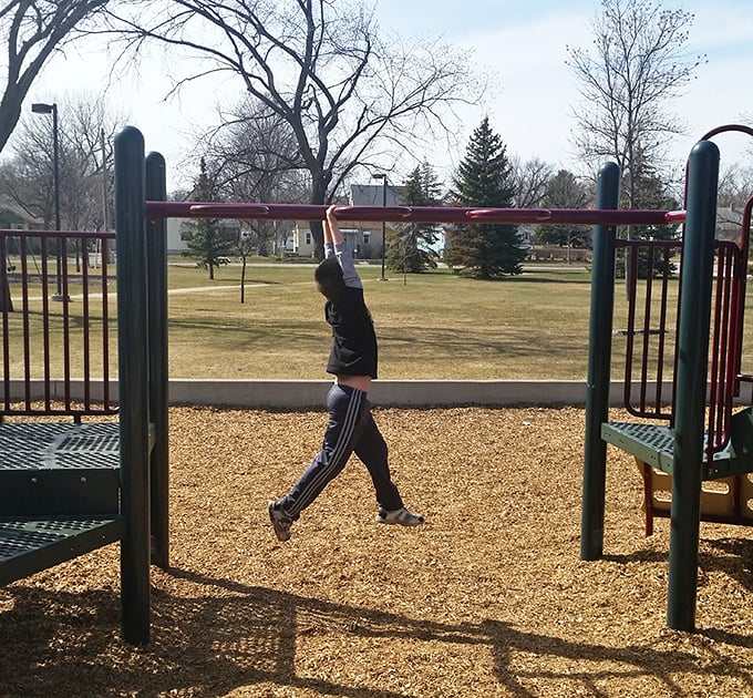 At Frontier Park, playground equipment awaits young adventurers while parents reminisce about their own childhood climbs.