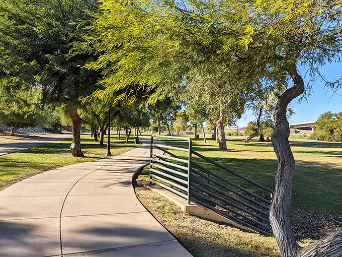 Gateway Park's winding paths invite leisurely strolls under mesquite trees. Nature's sunscreen courtesy of those perfectly placed branches.