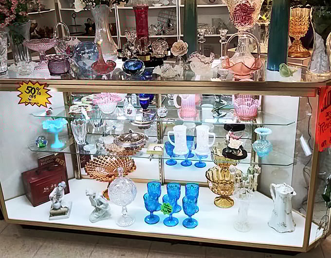 Colorful glassware catches the light like edible jewels, turning ordinary shelves into displays worthy of your grandmother's china cabinet.