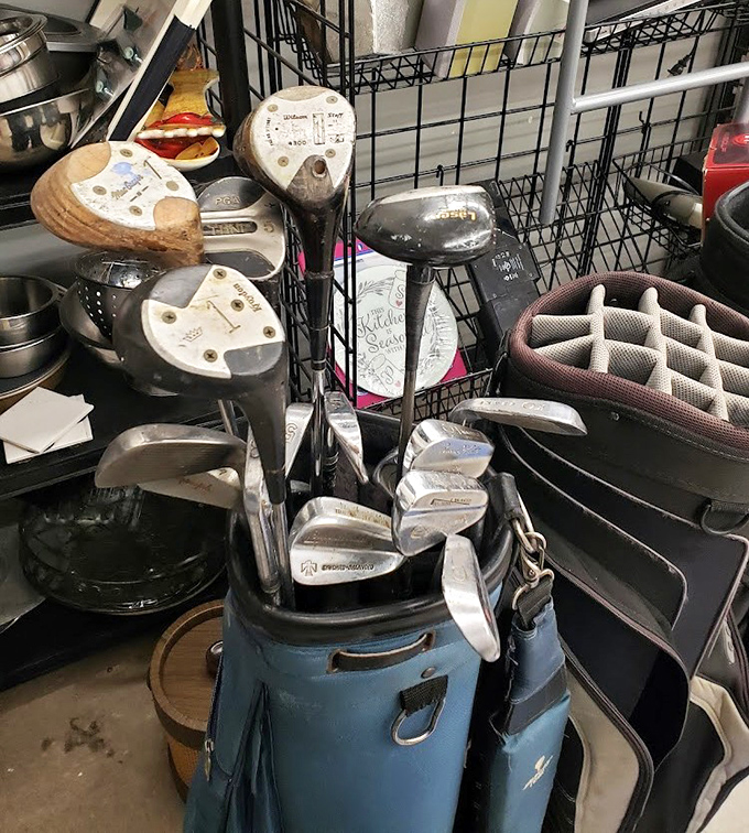 Golf clubs lean patiently, dreaming of fairways and that elusive hole-in-one that's surely coming next time.