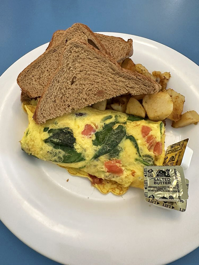 The Greek omelet – where spinach and feta find their true purpose in life. Those home fries are the unsung heroes of this breakfast symphony.