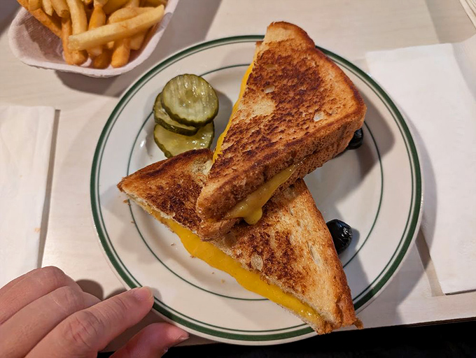 The grilled cheese sandwich: proof that perfection requires only three ingredients and the wisdom to leave well enough alone.