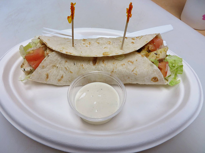 This chicken wrap isn't just lunch; it's a portable feast secured with toothpicks like tiny flavor guardrails.