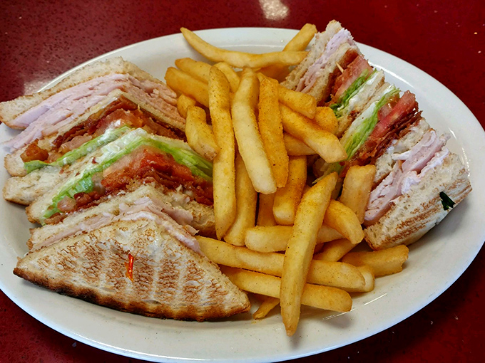 This club sandwich stands taller than some Florida condos, with layers that require an engineering degree to eat gracefully.