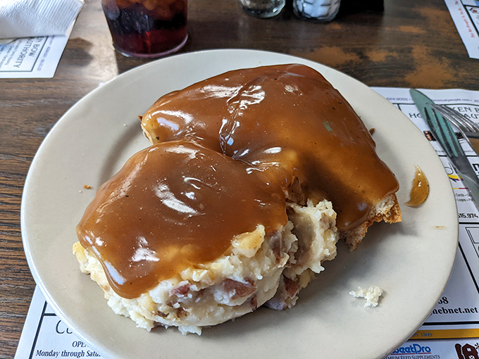 Hot beef sandwich swimming in gravy &ndash; the kind of dish that makes you want to hug the cook and take a nap immediately afterward. 