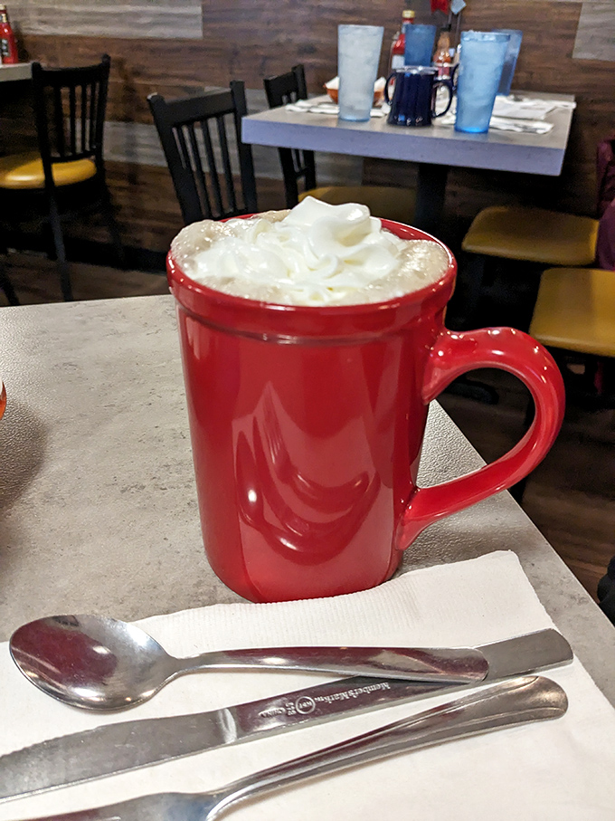 That red mug isn't just serving hot chocolate—it's delivering a warm hug in liquid form, complete with a whipped cream pillow.