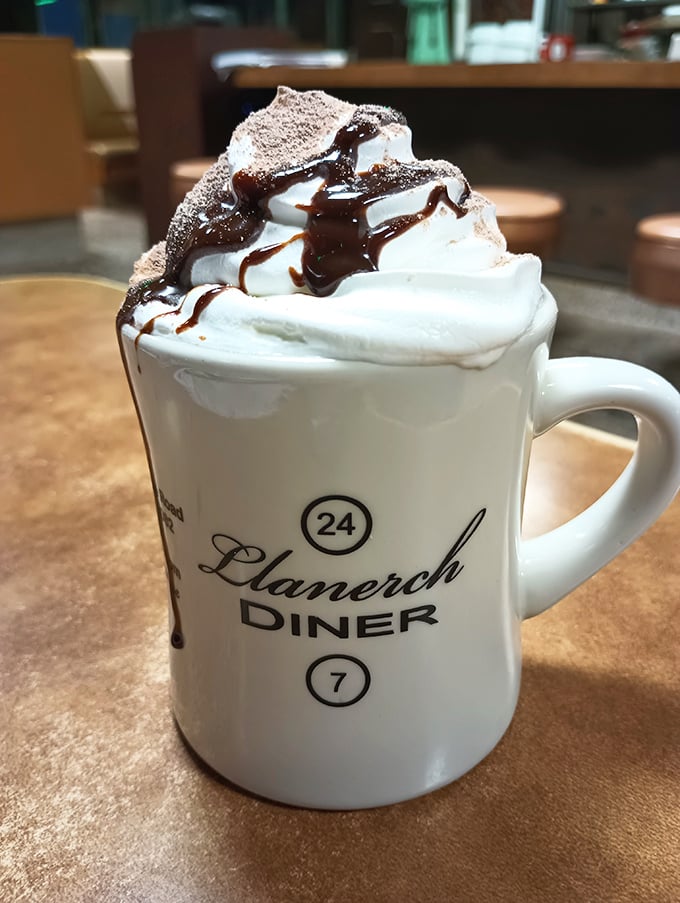 Not just hot chocolate&mdash;a mug of liquid happiness topped with a cloud of whipped cream and chocolate drizzle in the diner's signature mug.