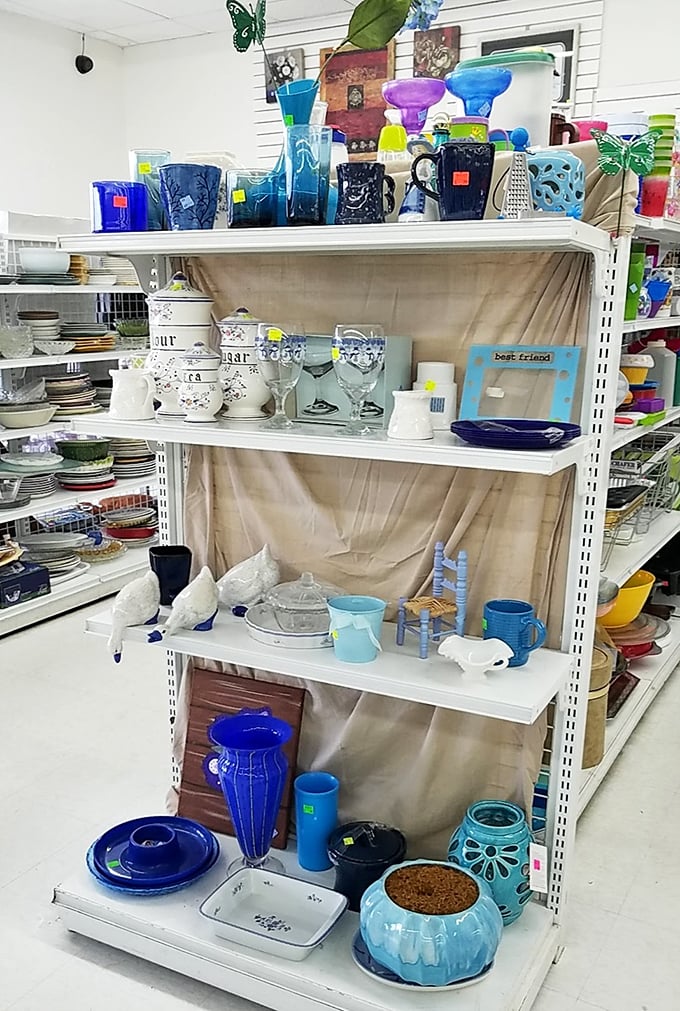 Blue glass vases neighbor white ceramic sugar bowls in this domestic United Nations. The perfect mismatched set awaits someone with an eye for eclectic charm.