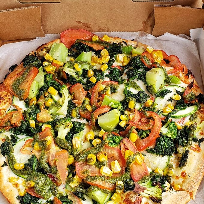 A veggie-lover's dream where broccoli, corn, and tomatoes prove that plant-based toppings deserve the spotlight on any pizza stage.