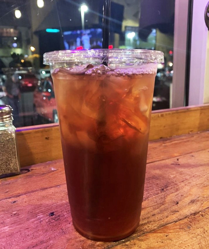 Sweet tea in the South is religion; at Badlands it's salvation after a spicy bite. Amber liquid catching the evening light, promising refreshment with every sip.