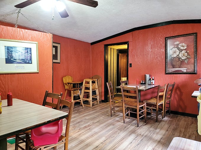 Another dining room showcases those signature orange walls&mdash;a decorating choice that somehow feels both boldly retro and perfectly appropriate.
