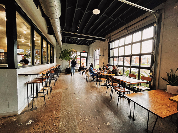 Where the magic happens. Sunlight streams through garage-style windows, illuminating a space where conversations and coffee flow with equal ease.