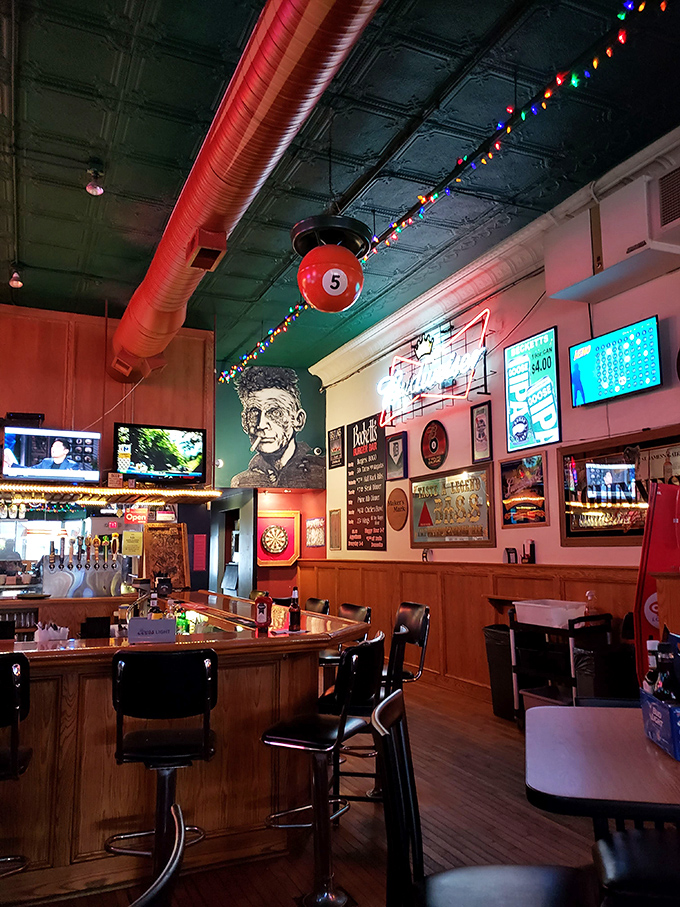 The bar area balances sports-watching practicality with unexpected charm &ndash; note the vintage-inspired ceiling and playful billiard ball hanging among the festive lights.