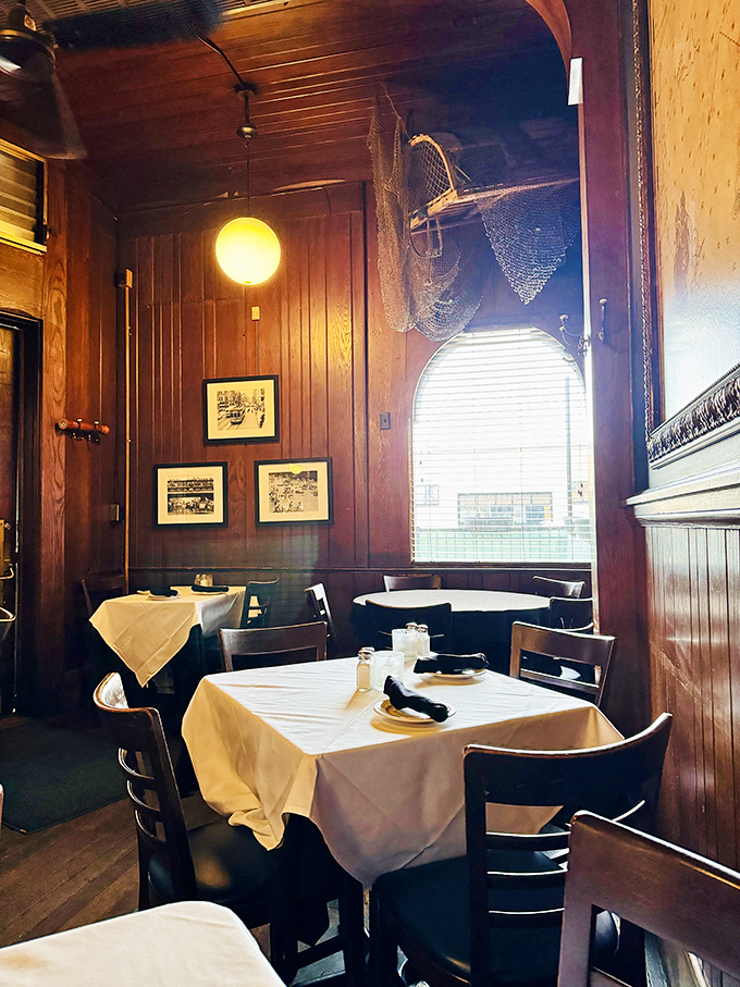 Fishing nets and warm wood create a dining room that feels like the captain's quarters of a very delicious ship. Maritime charm without the seasickness.