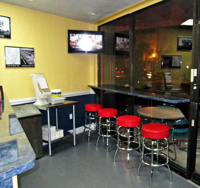 Classic diner-style seating with those iconic red stools creates the perfect perch for late-night hot dog indulgence after Miami's nightlife.