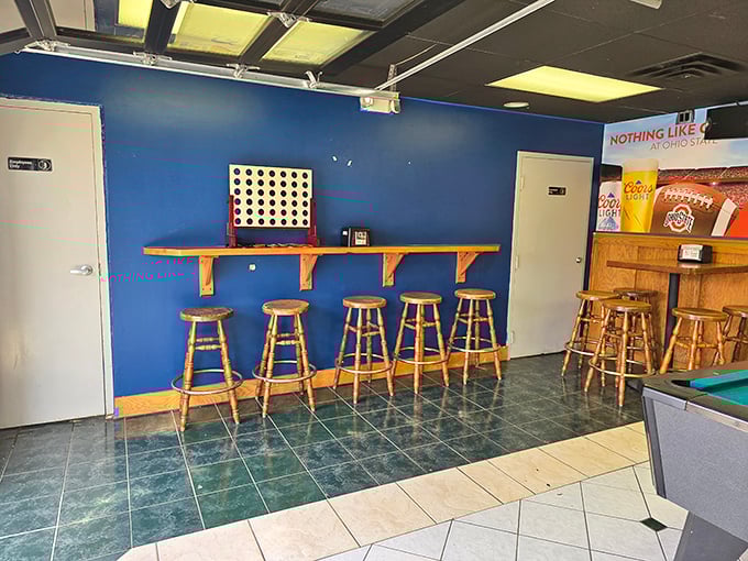 The blue walls and wooden stools create that perfect neighborhood hangout vibe where you can challenge friends to Connect Four between pizza slices.