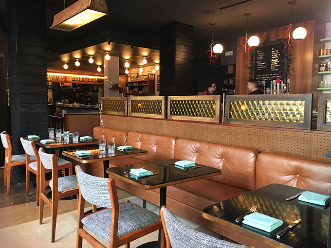Those caramel-colored leather banquettes practically beg you to slide in and stay awhile. The lighting fixtures add just the right amount of mid-century charm.