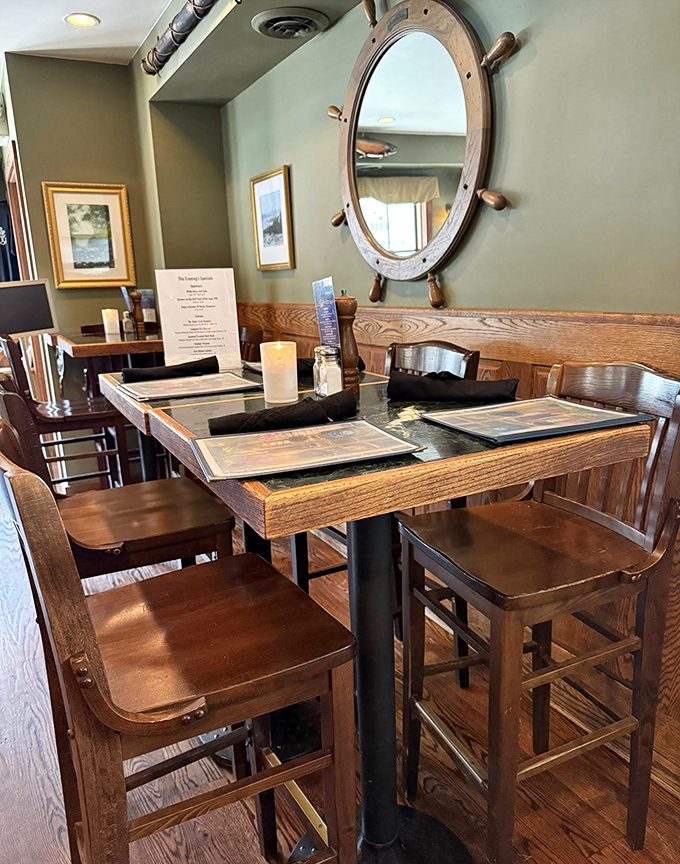 A ship's wheel mirror anchors the nautical theme, while wooden tables invite you to settle in for a feast worthy of Neptune himself.