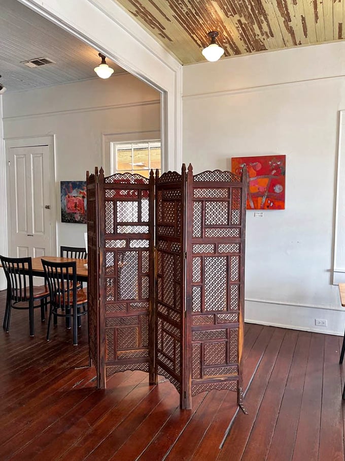 Vintage meets modern in this thoughtfully designed space where wooden dividers create intimate nooks for coffee contemplation.
