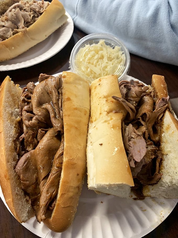 Behold the art of sandwich architecture! Tender roast beef piled high with a side of cheese for DIY perfection &ndash; because sometimes happiness comes on a paper plate.