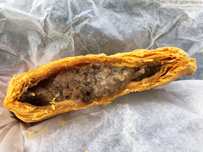 Plot twist: that's a Jamaican beef patty hiding in a Kentucky chicken joint, and nobody's complaining about it.